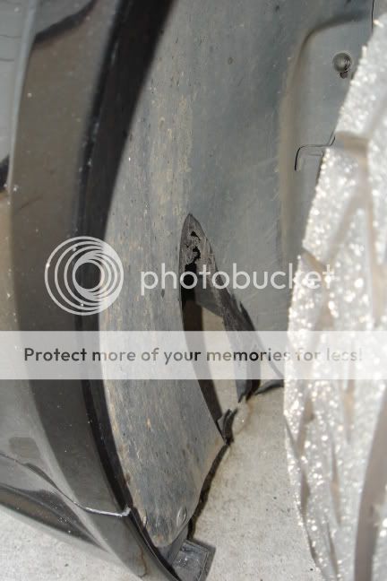 plastic "shield" over front tire musta come loose and tire ate it up ...